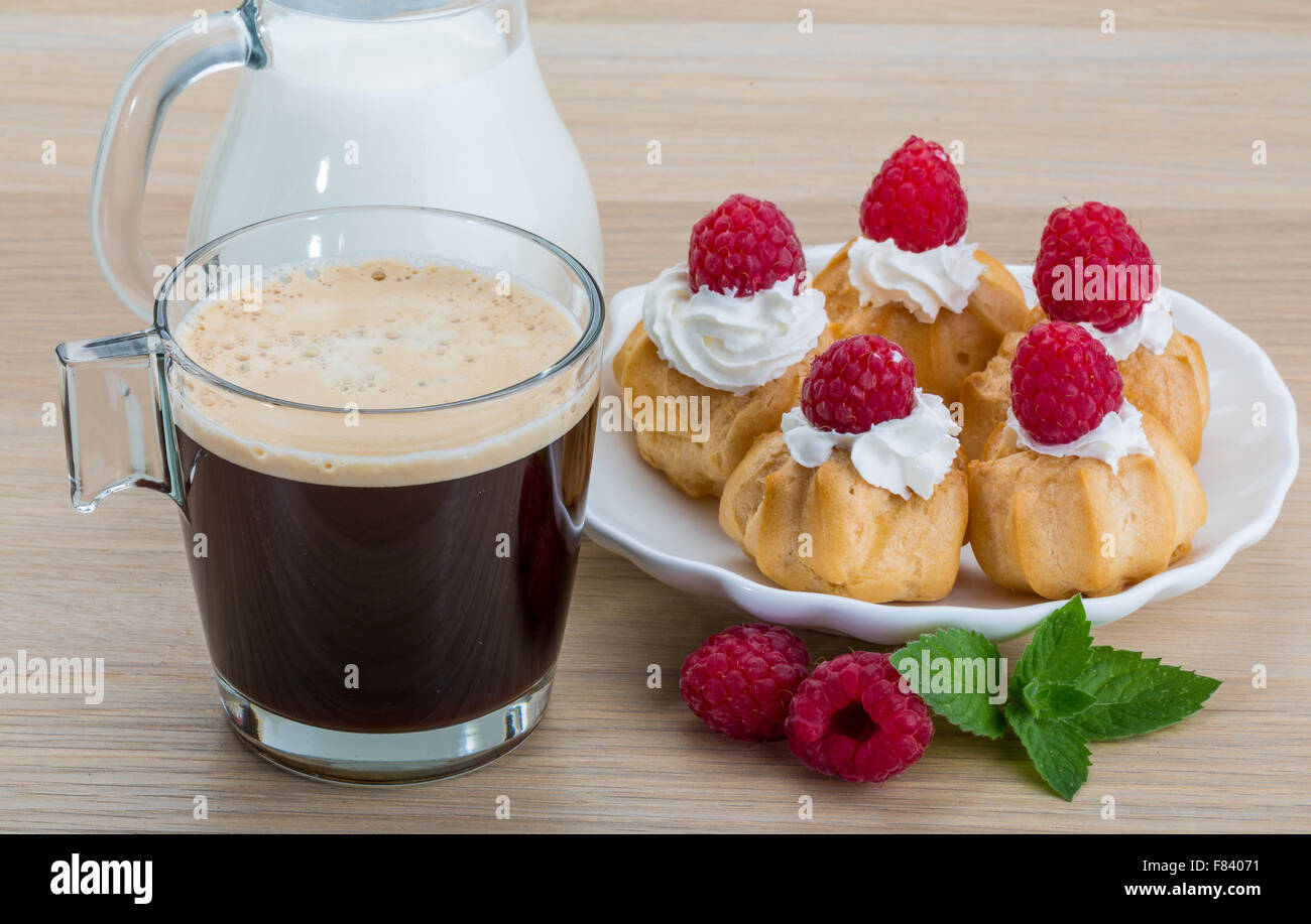 Profiterole with raspberry and cup of coffee Stock Photo - Alamy