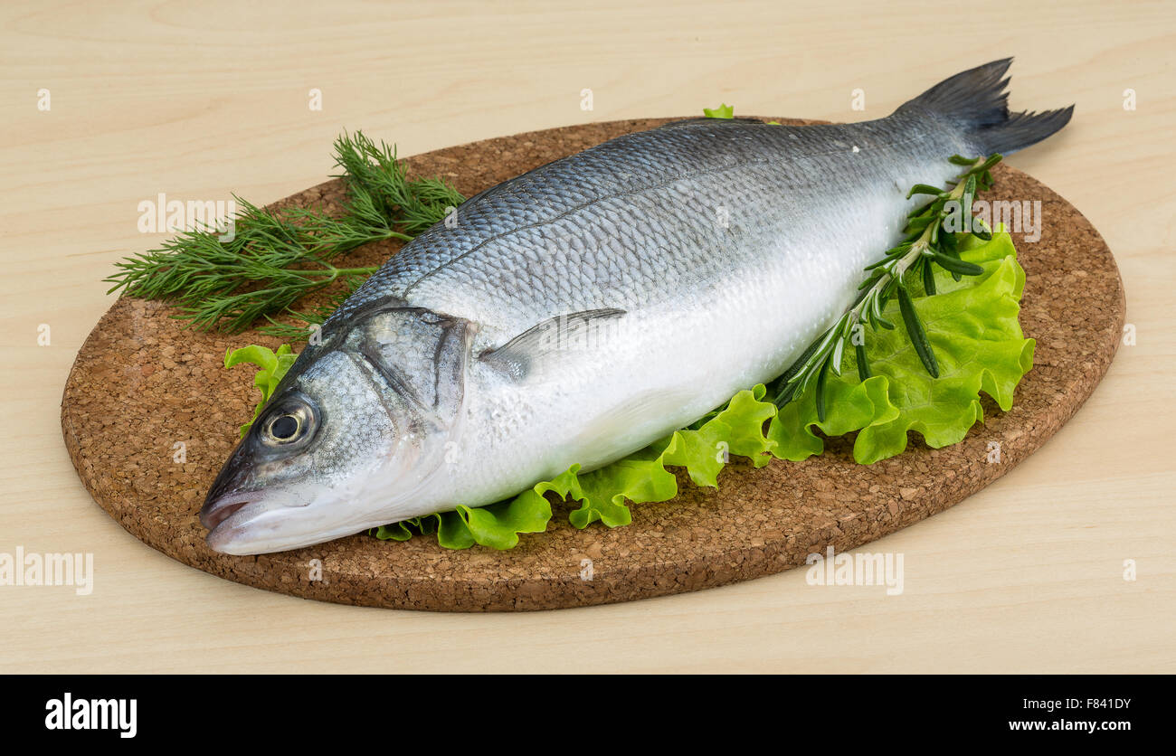 Raw seabass fish with rosemary and dill Stock Photo - Alamy