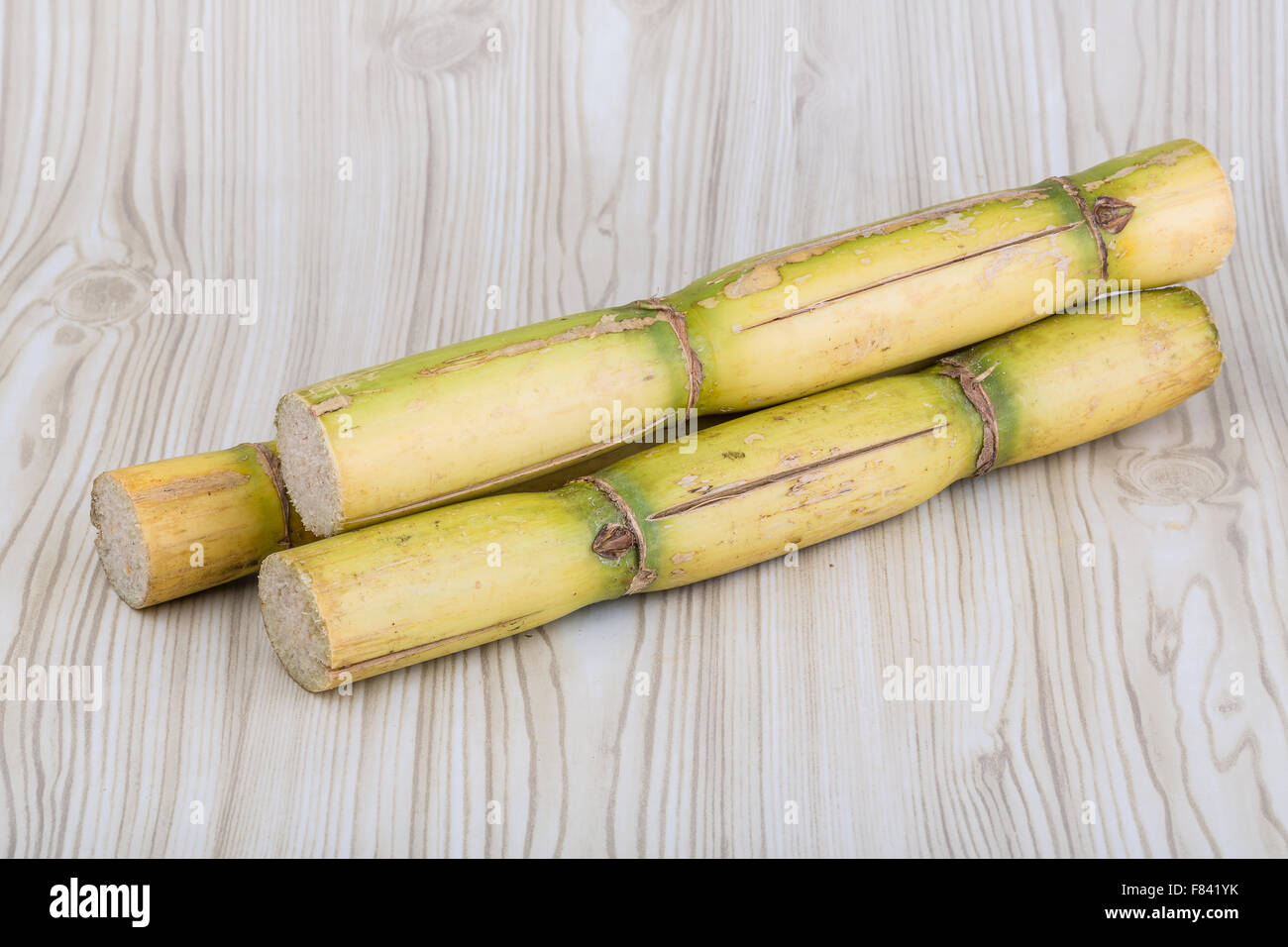Sugar reed sticks on the wooden background Stock Photo - Alamy