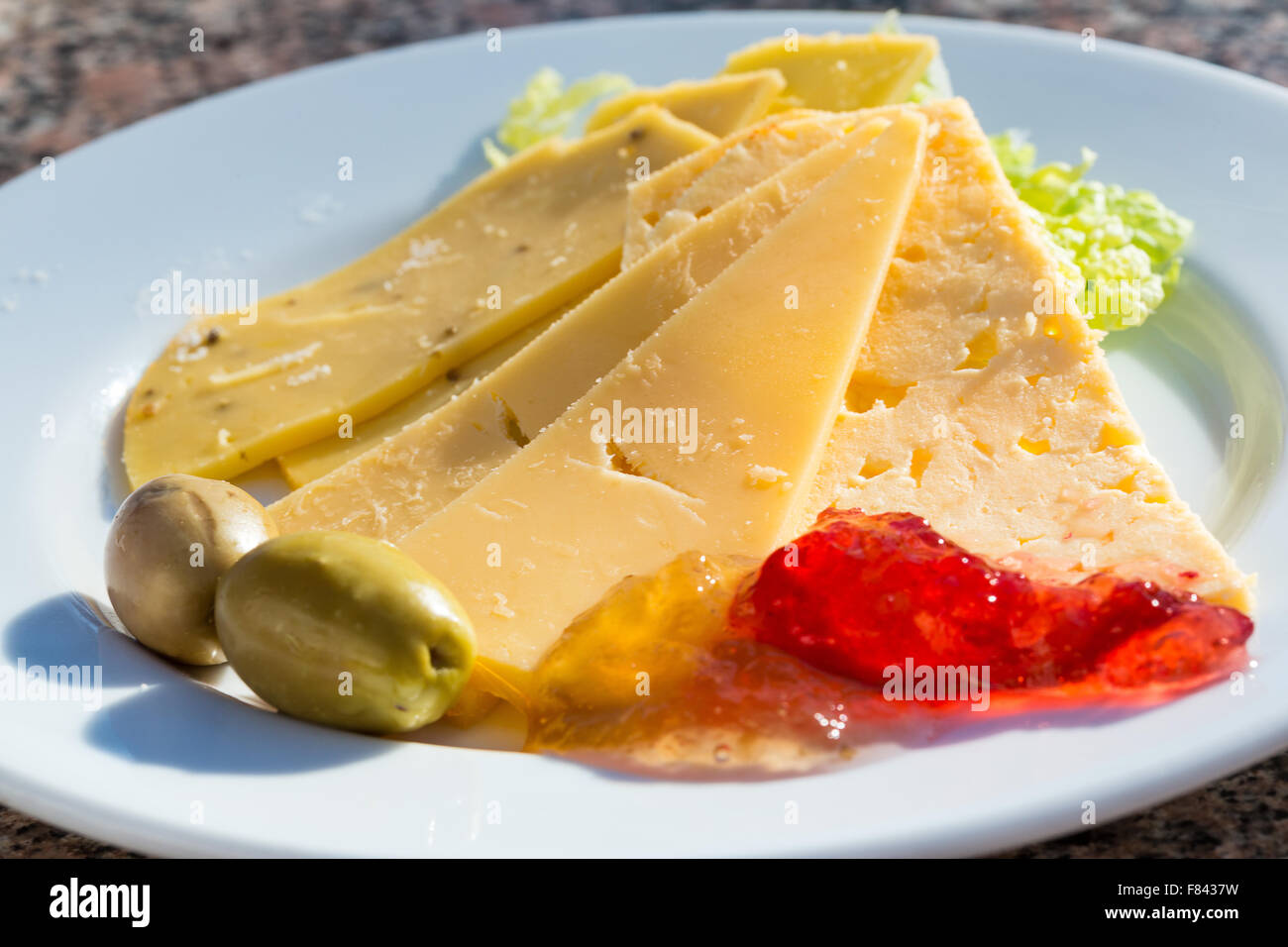 Various sliced cheeses with jam and salad leaves Stock Photo - Alamy