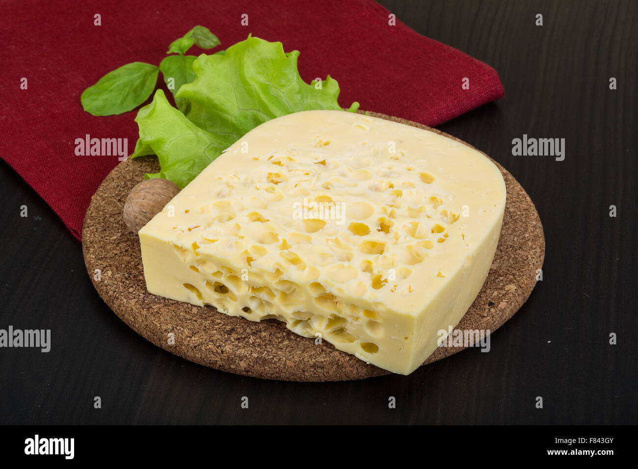 Yellow cheese - maasdam with salad leaves Stock Photo - Alamy
