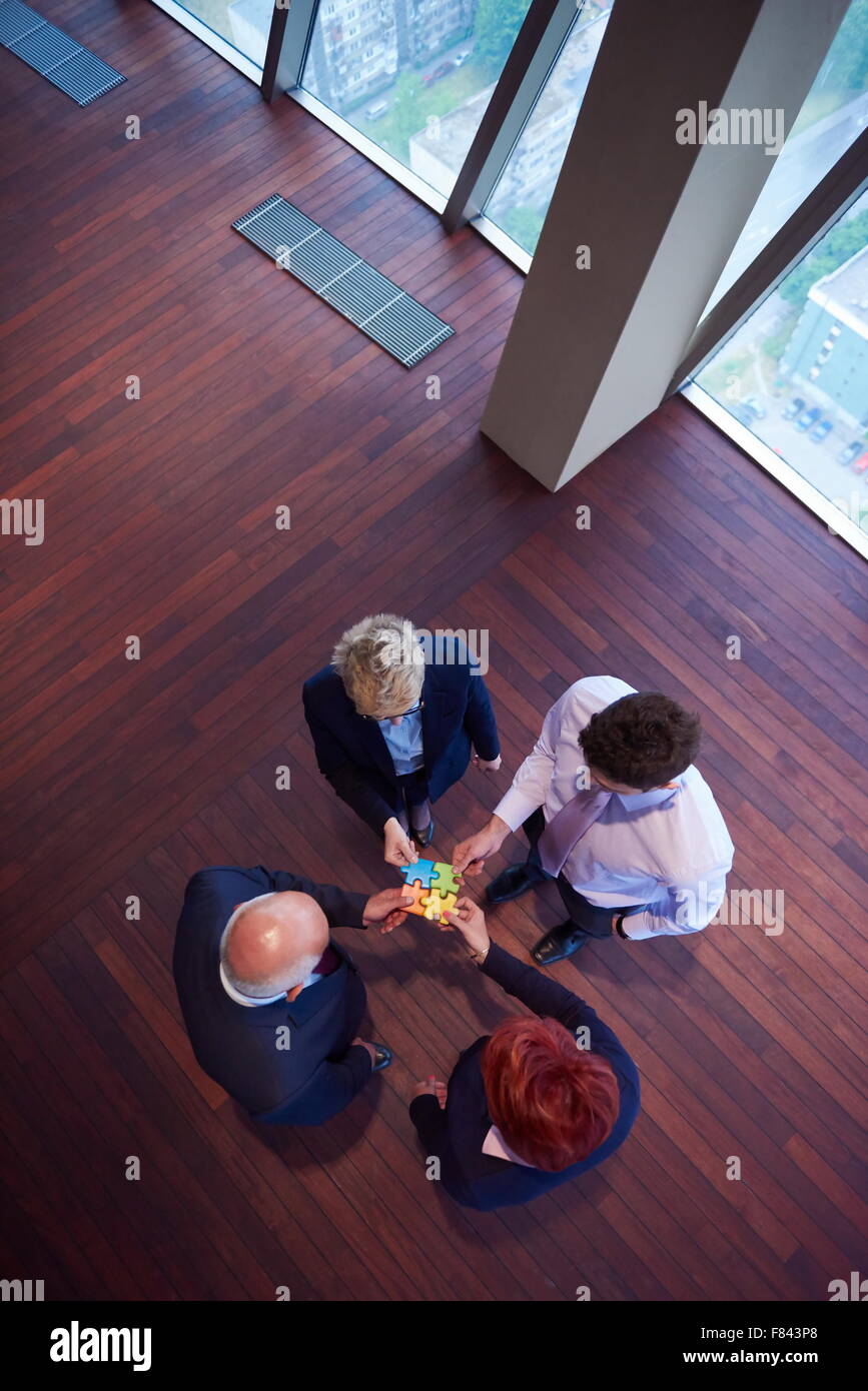 business people group assembling jigsaw puzzle and represent team ...