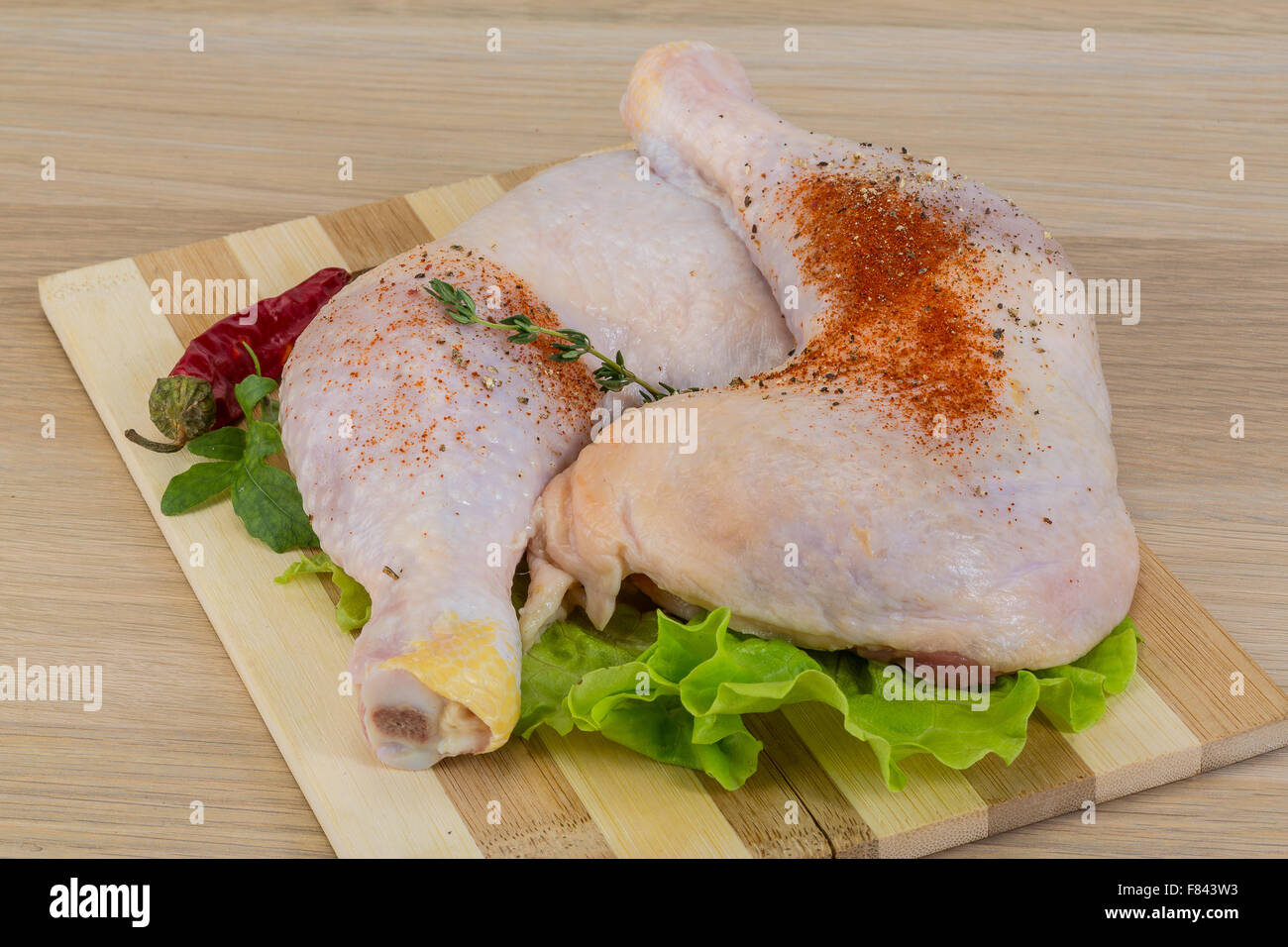 Raw chicken leg with herbs ready for cooking Stock Photo - Alamy