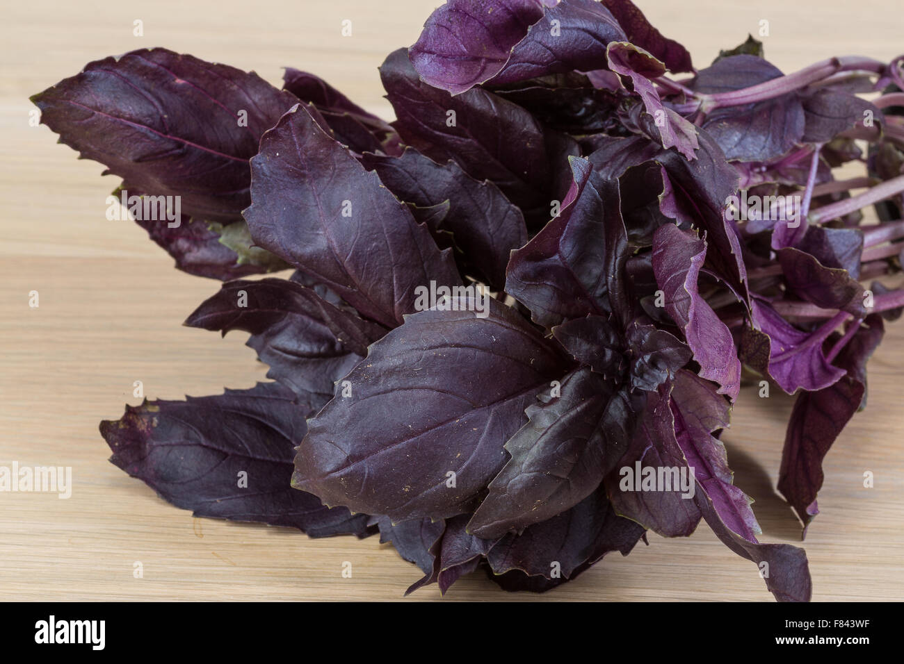 Violet basil leaves on the wood background Stock Photo - Alamy