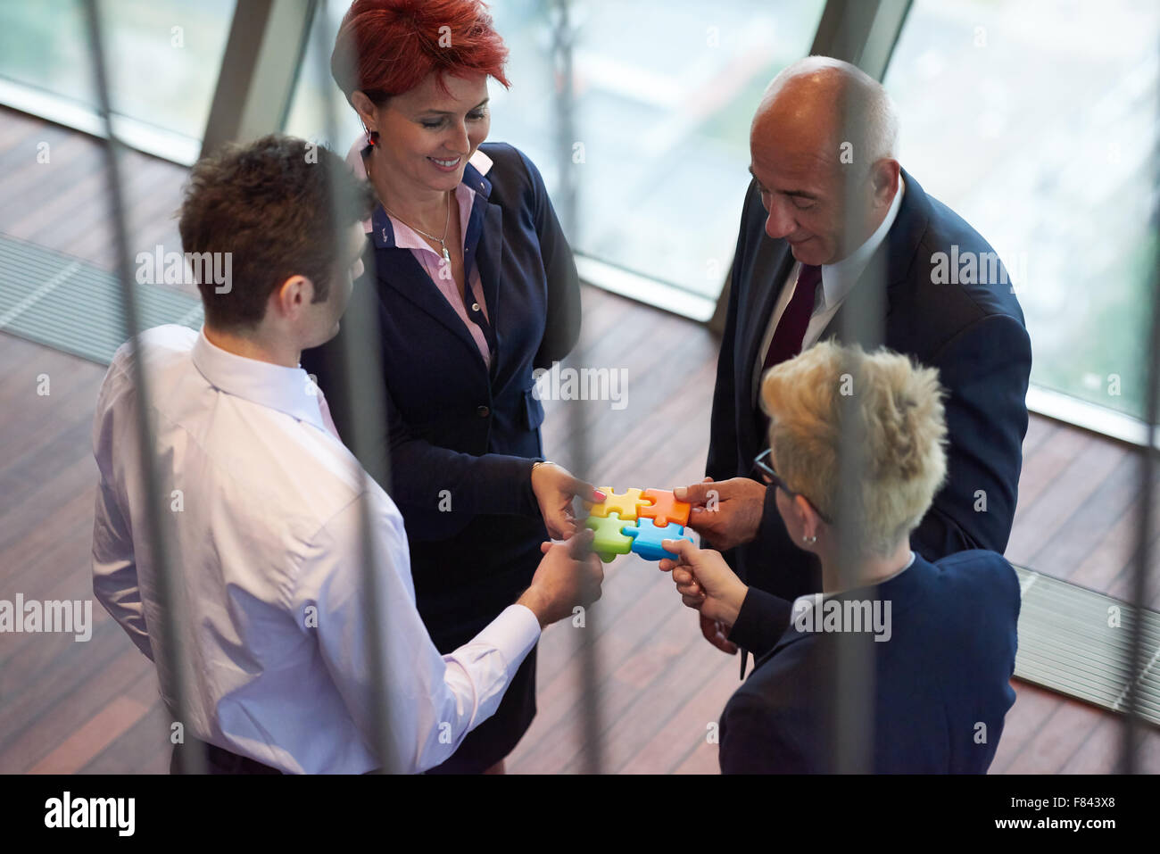 business people group assembling jigsaw puzzle and represent team ...