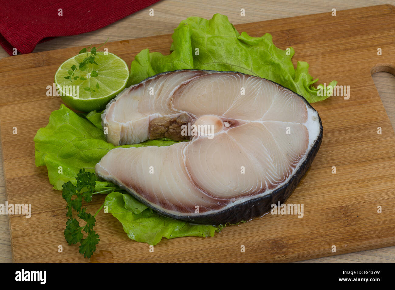 Raw blue shark steak with salad leaves and lime Stock Photo - Alamy