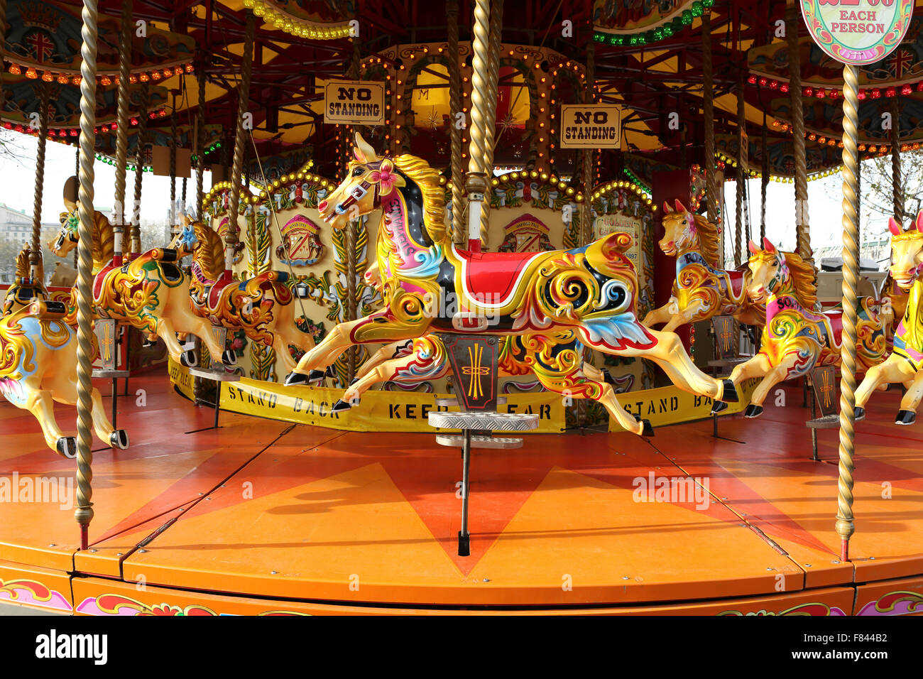 A Merry-Go-Round in London, UK. Colourful horses can be ridden on the ...