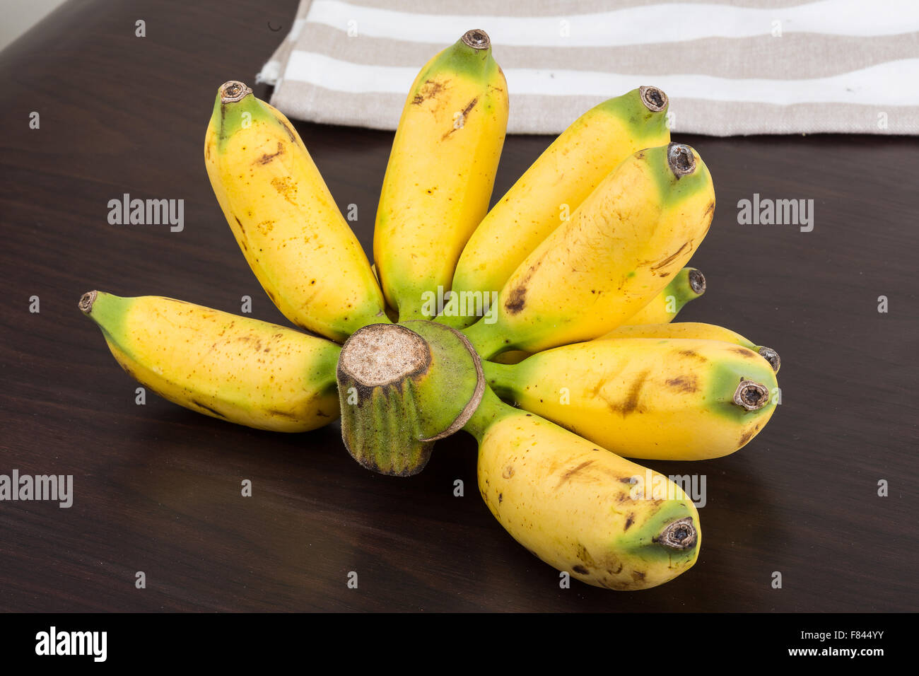 Fresh Baby bananas on the wood background Stock Photo - Alamy