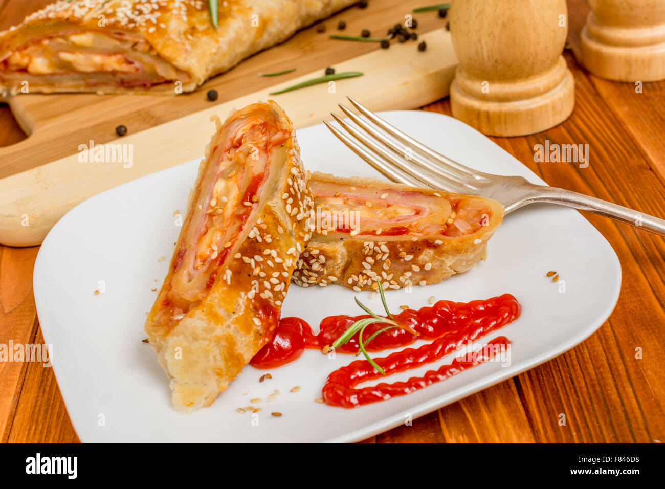 Puff pastry roll with cheese and ham Stock Photo - Alamy