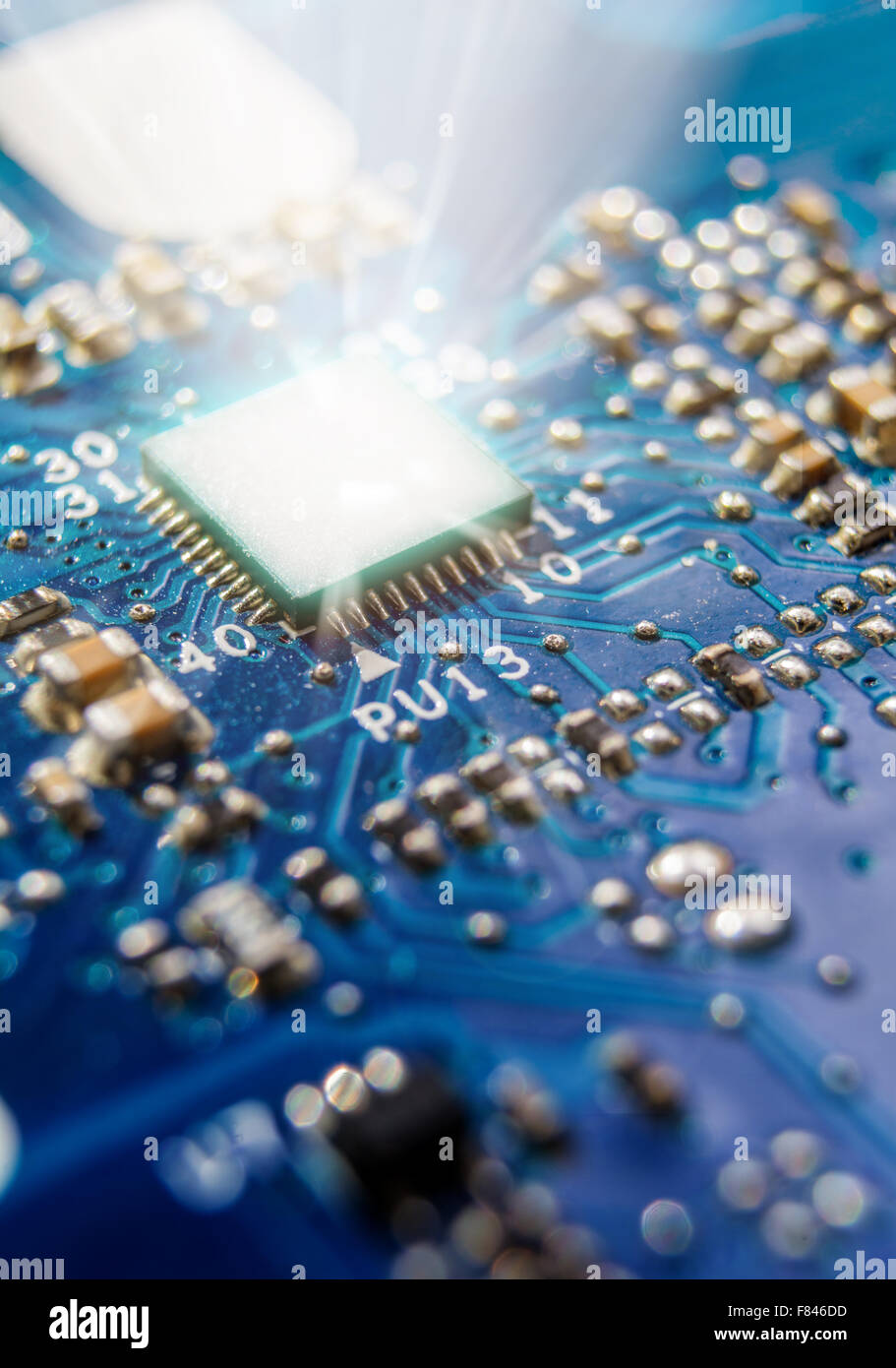 Blue electronic circuit board with glow close up Stock Photo - Alamy
