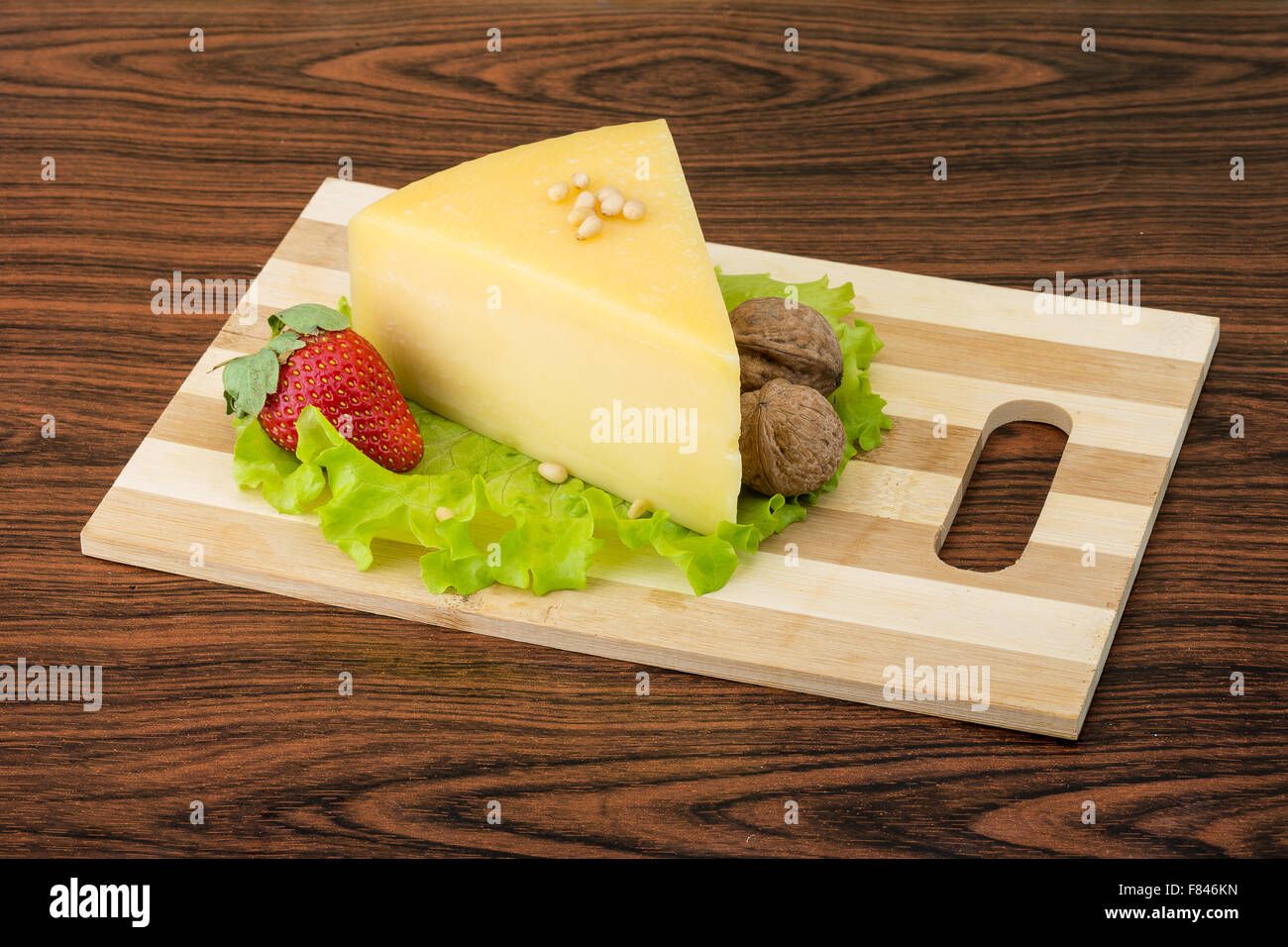 Parmesan cheese triangle with strawberry and wallnuts Stock Photo - Alamy