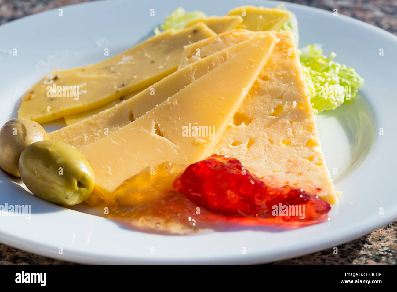 Various sliced cheeses with jam and salad leaves Stock Photo - Alamy
