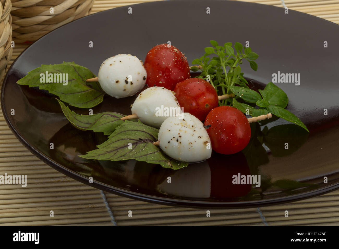 Famous italian caprese salad with fresh basil leaves Stock Photo - Alamy