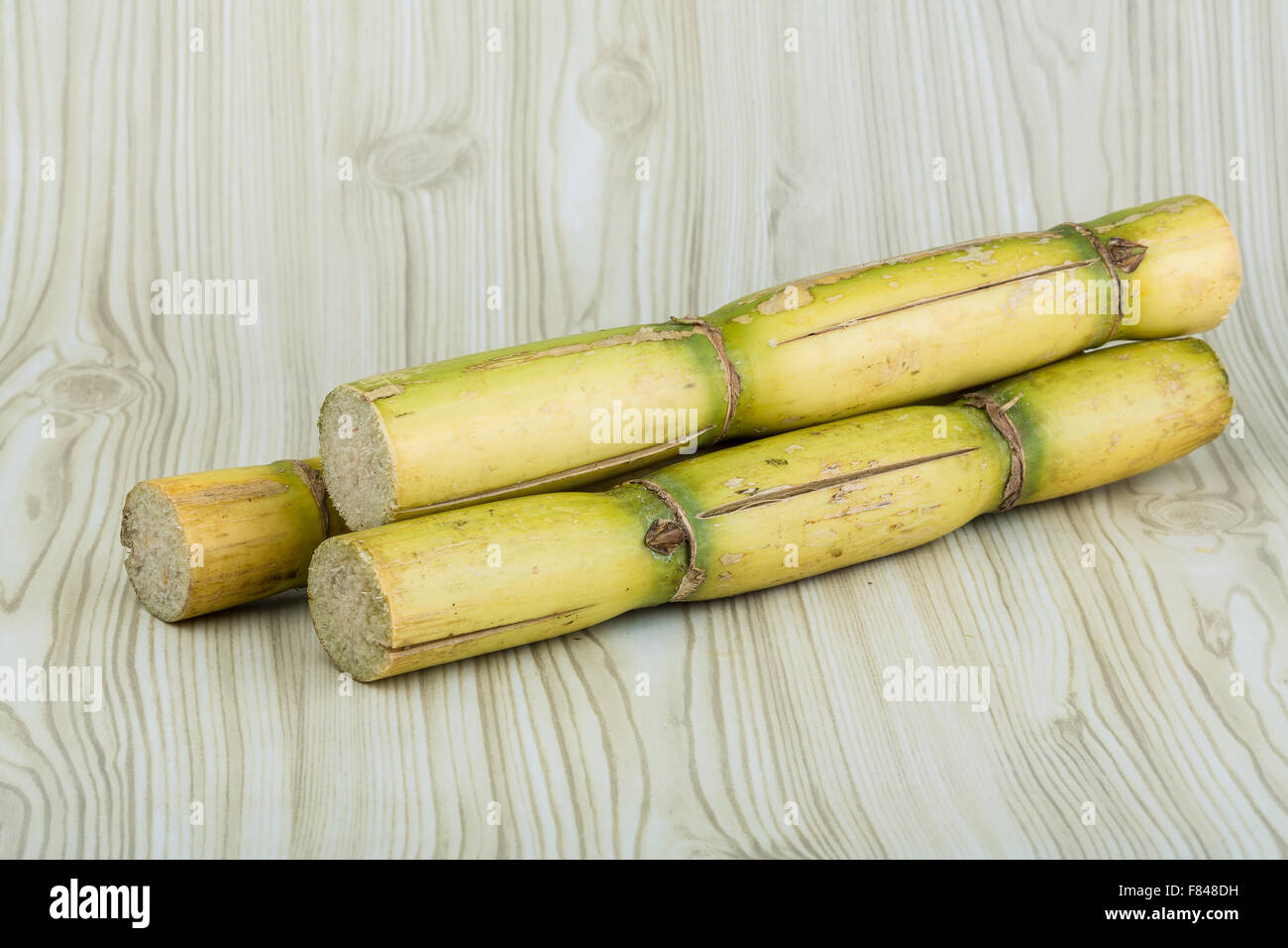 Sugar reed sticks on the wooden background Stock Photo - Alamy