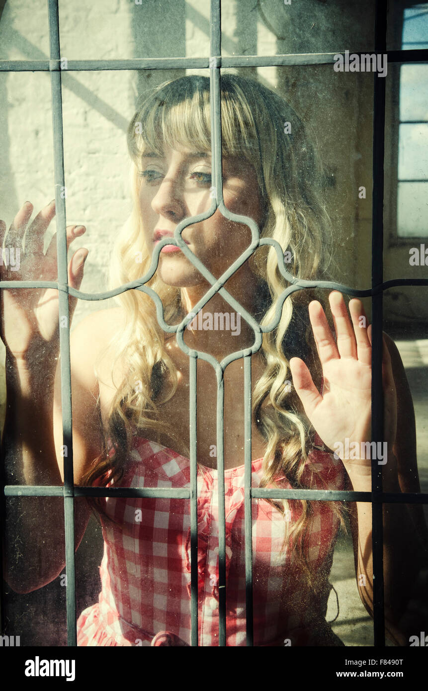 Young woman looking out of the window Stock Photo - Alamy