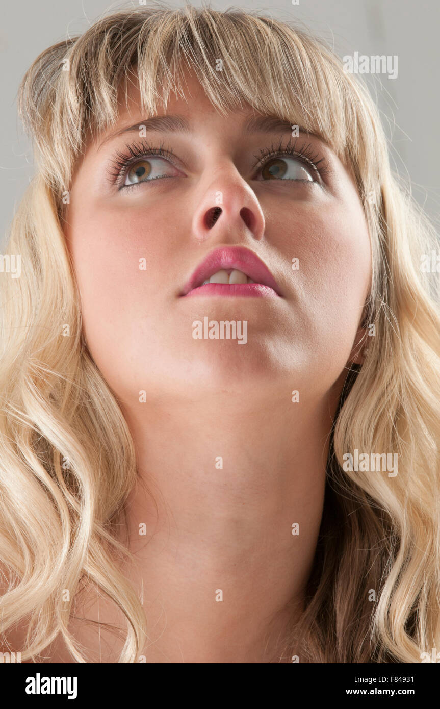 Serious woman looking up Stock Photo - Alamy