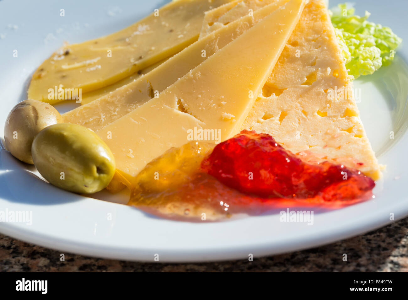 Various sliced cheeses with jam and salad leaves Stock Photo - Alamy