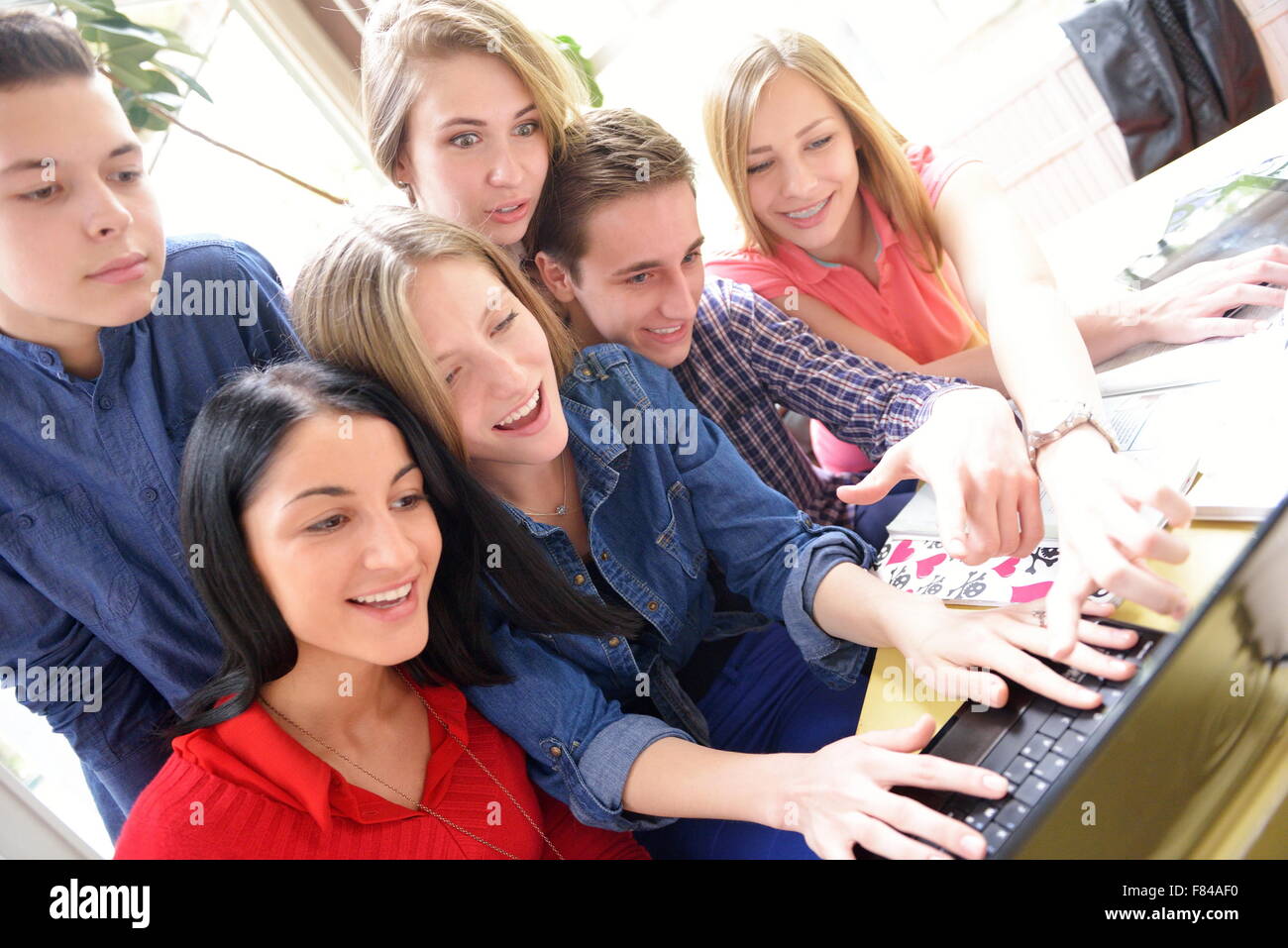 happy young teens group in school have fun an learning lessons Stock ...