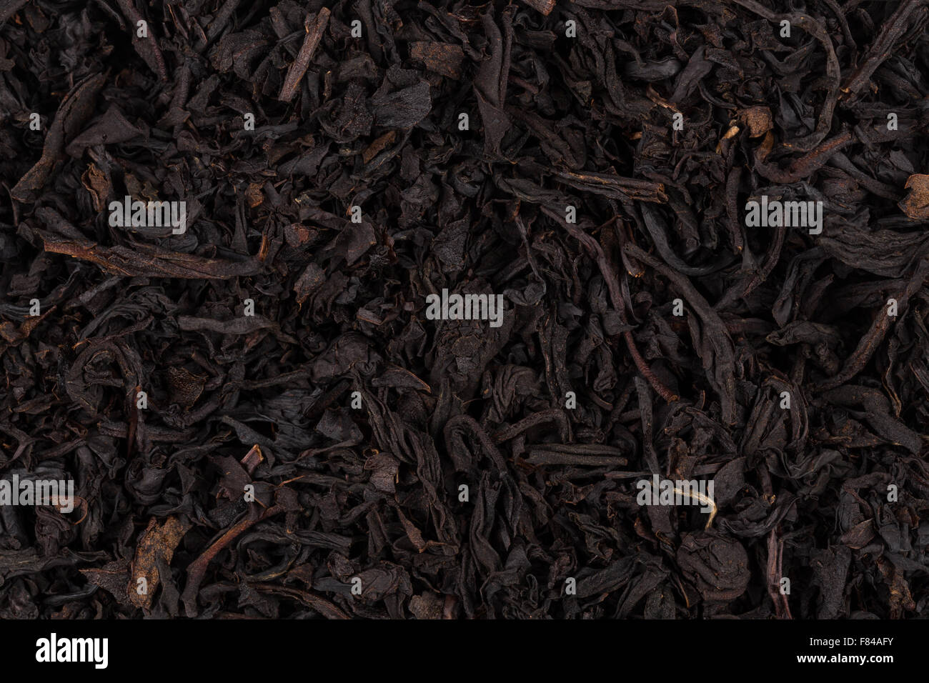 dry black tea leaves close up of texture for background Stock Photo - Alamy