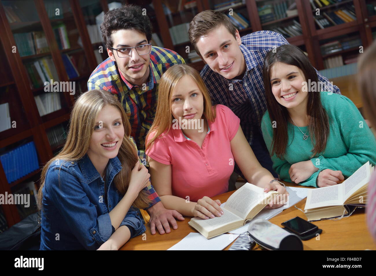 happy young teens group in school have fun an learning lessons Stock ...