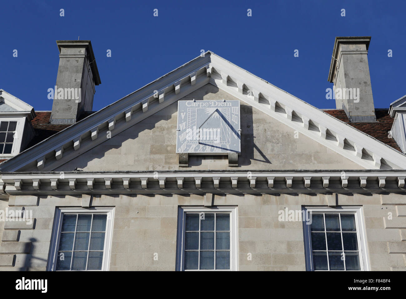 A sundial on the facade of a building in Lewes, England. The dial tells ...