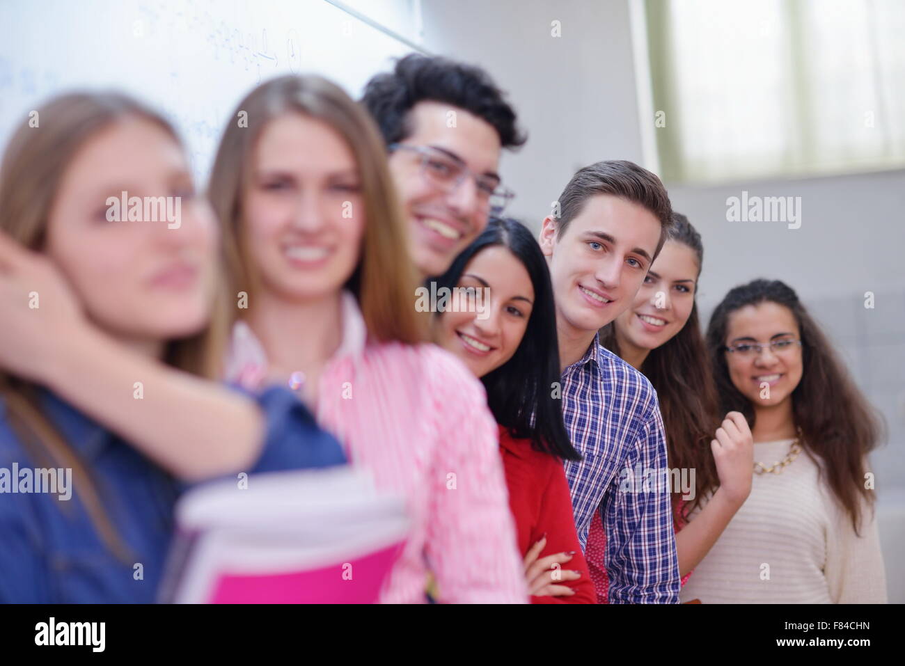 happy young teens group in school have fun an learning lessons Stock ...