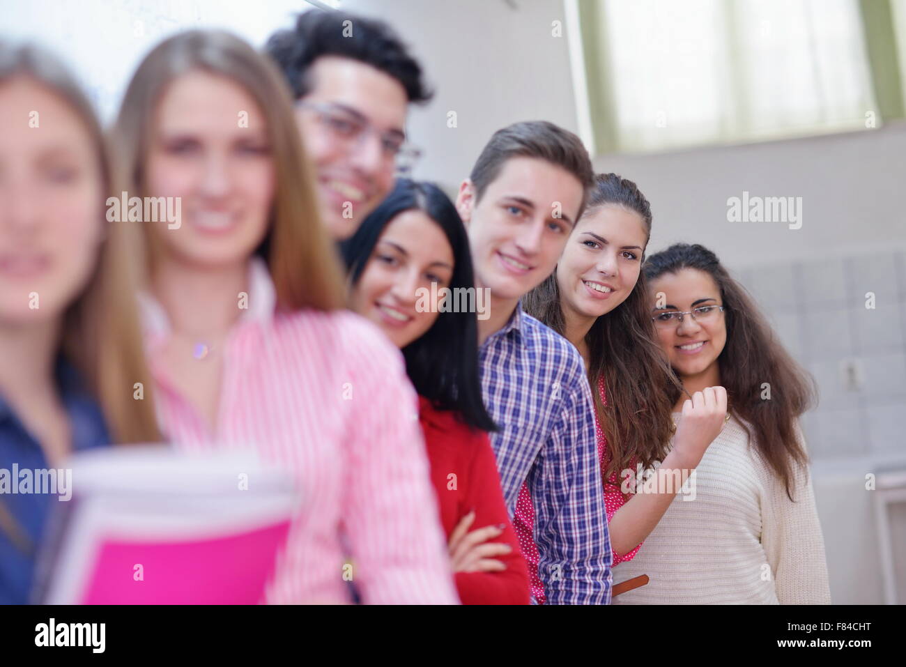 happy young teens group in school have fun an learning lessons Stock ...