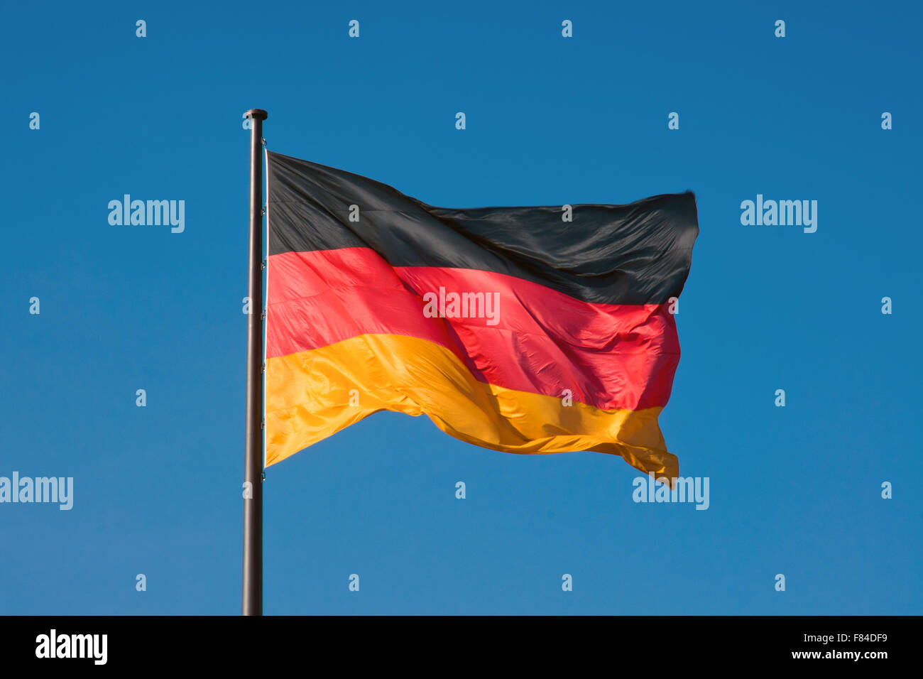 The German flag waving in the wind Stock Photo - Alamy