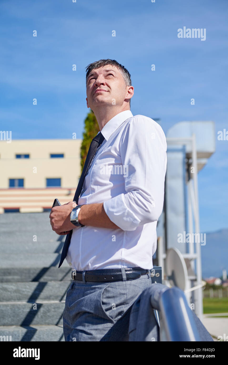 portrait of middle aged business man standing outdoor on stairs Stock ...