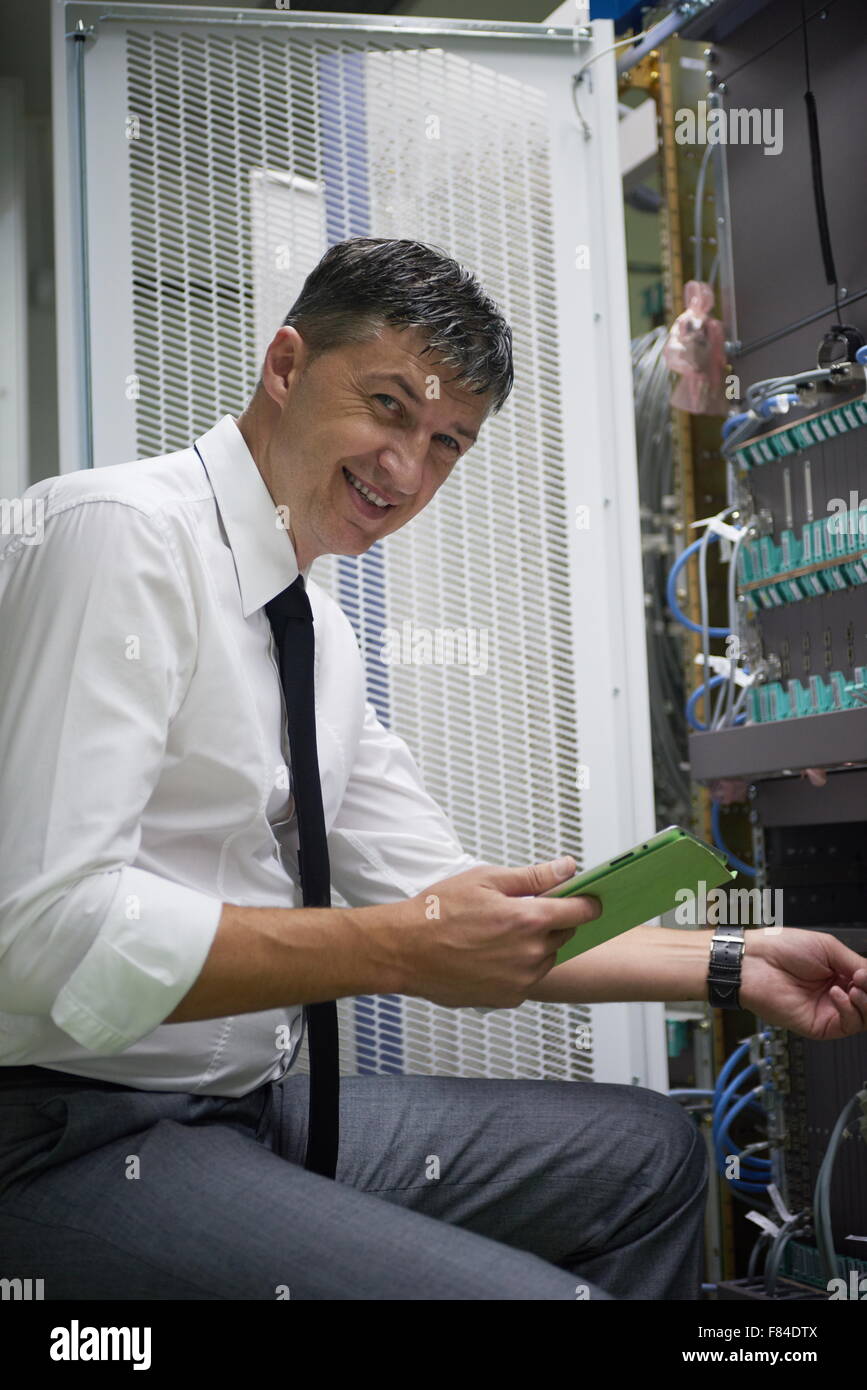 network engineer working in server room, corporate business man working ...