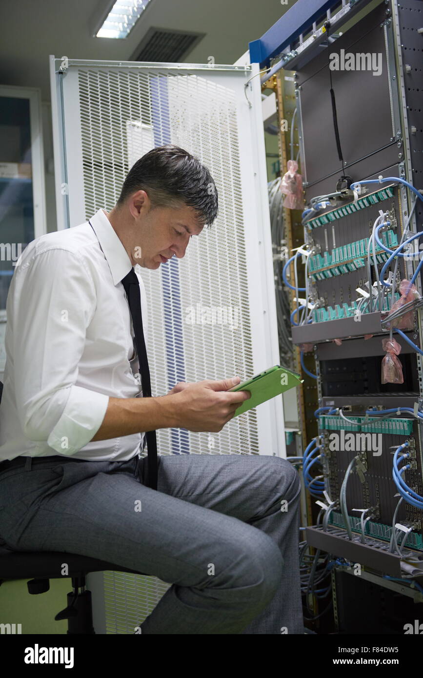 network engineer working in server room, corporate business man working ...