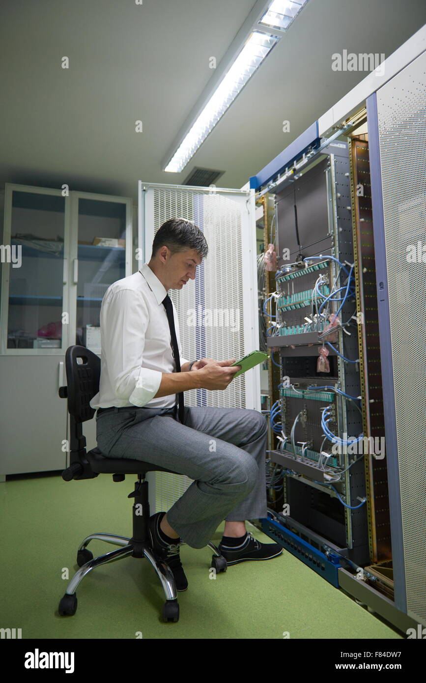 network engineer working in server room, corporate business man working ...