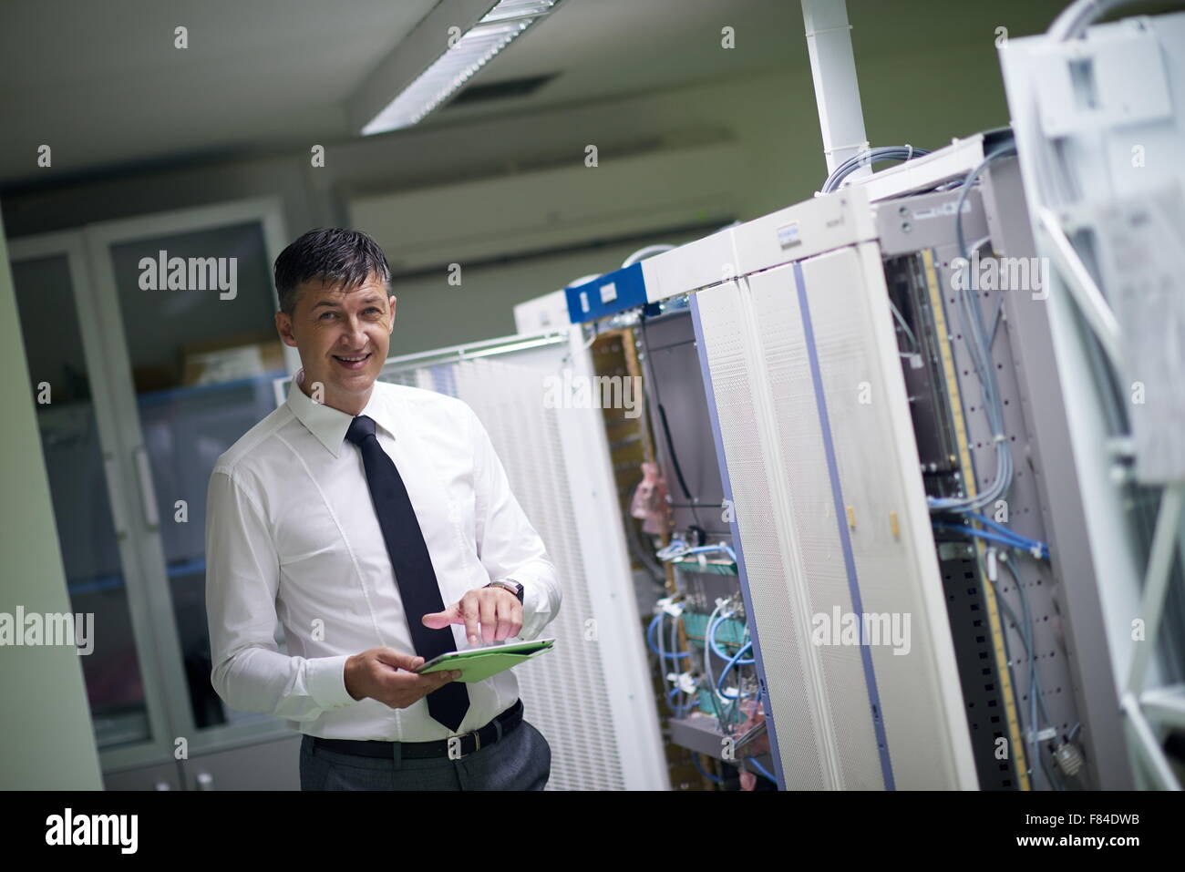 network engineer working in server room, corporate business man working ...