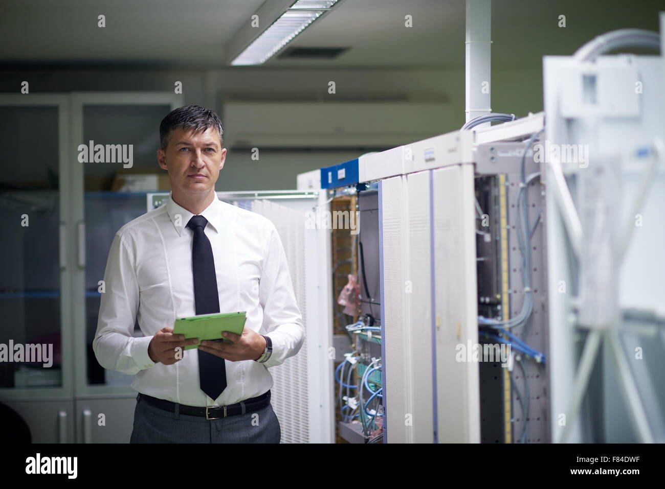 network engineer working in server room, corporate business man working ...