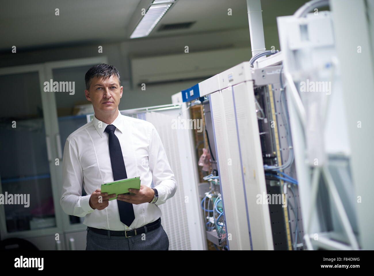 network engineer working in server room, corporate business man working ...