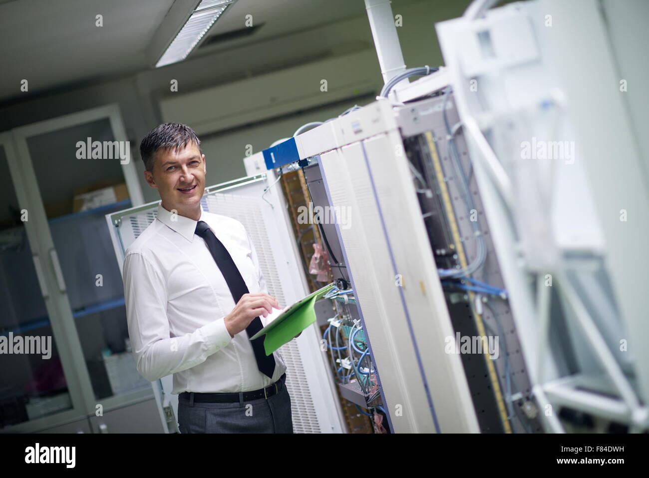 network engineer working in server room, corporate business man working ...