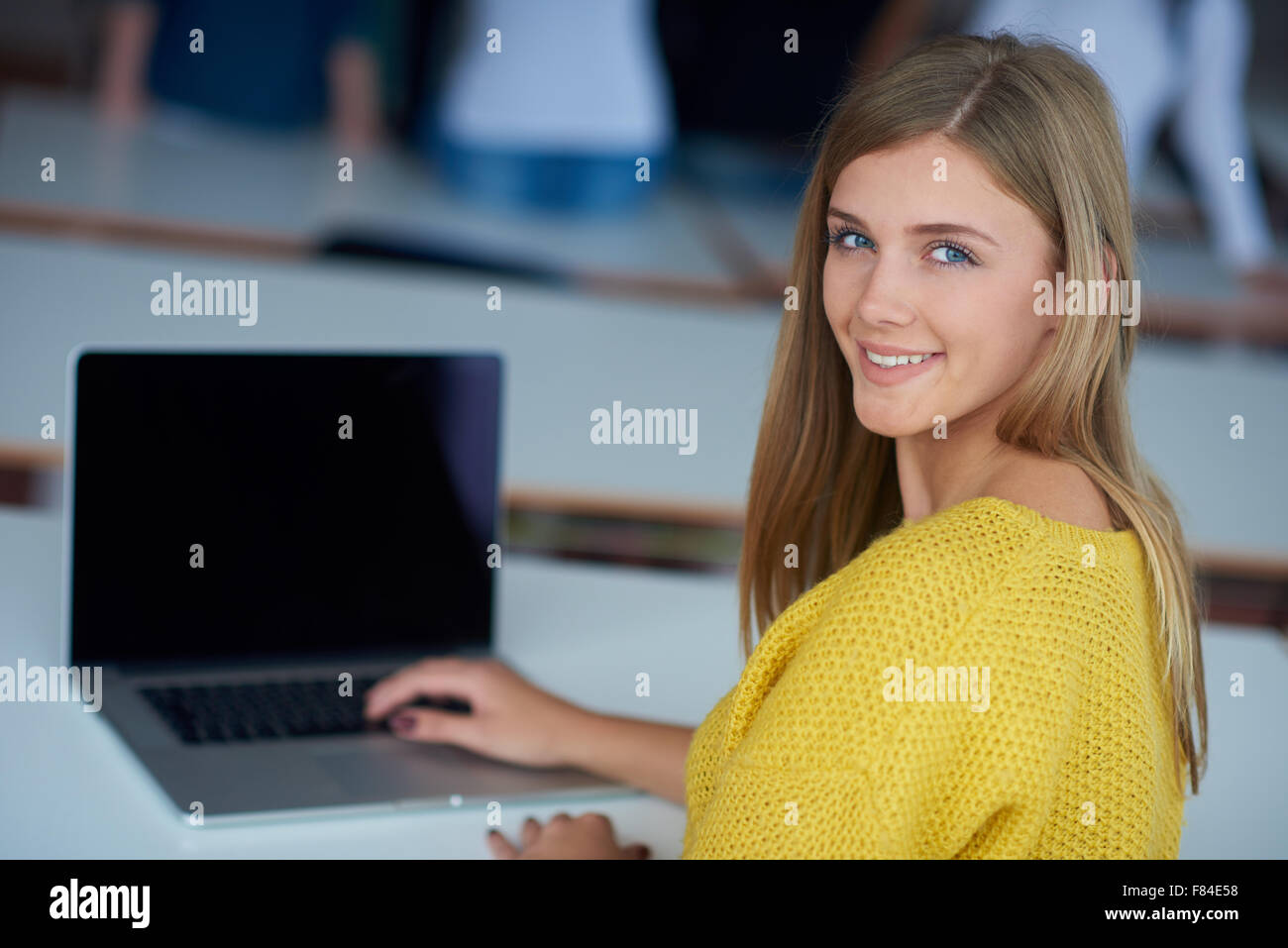 portrait of happy smilling student girl at tech classroom with laptop ...