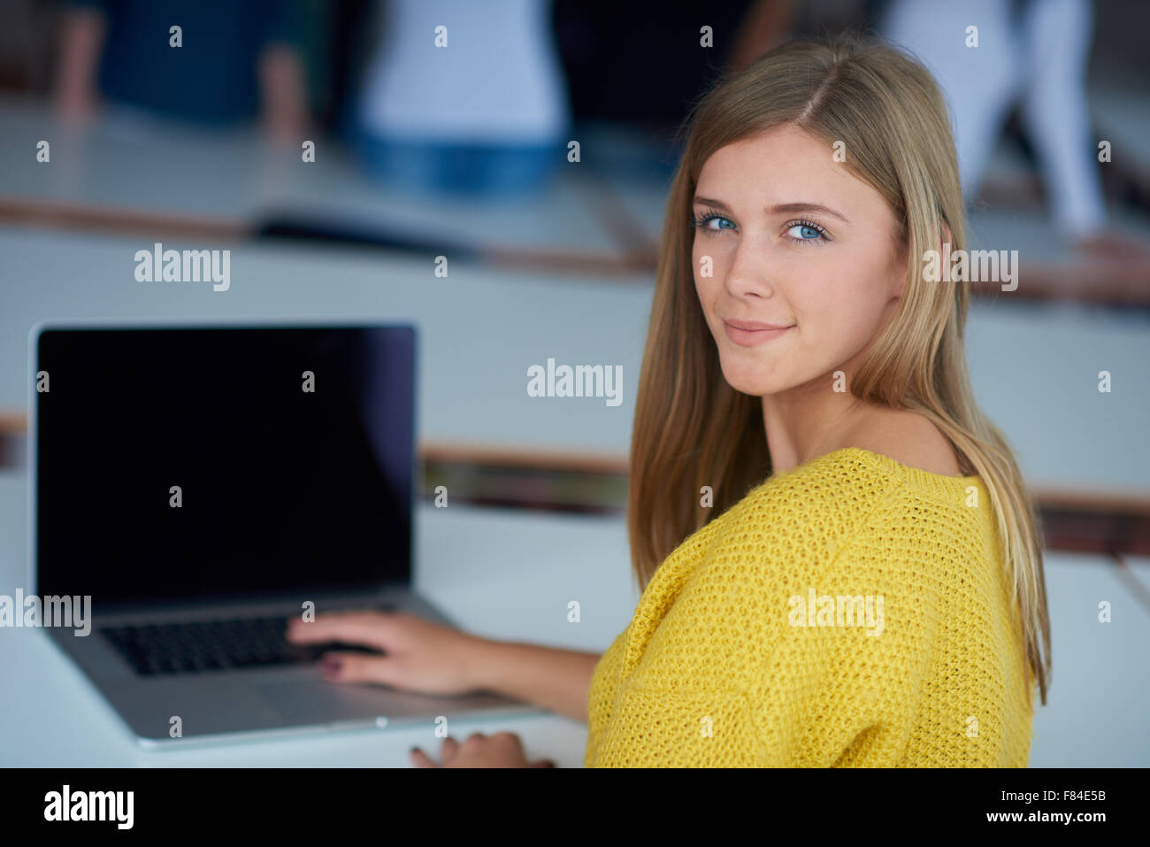 portrait of happy smilling student girl at tech classroom with laptop ...