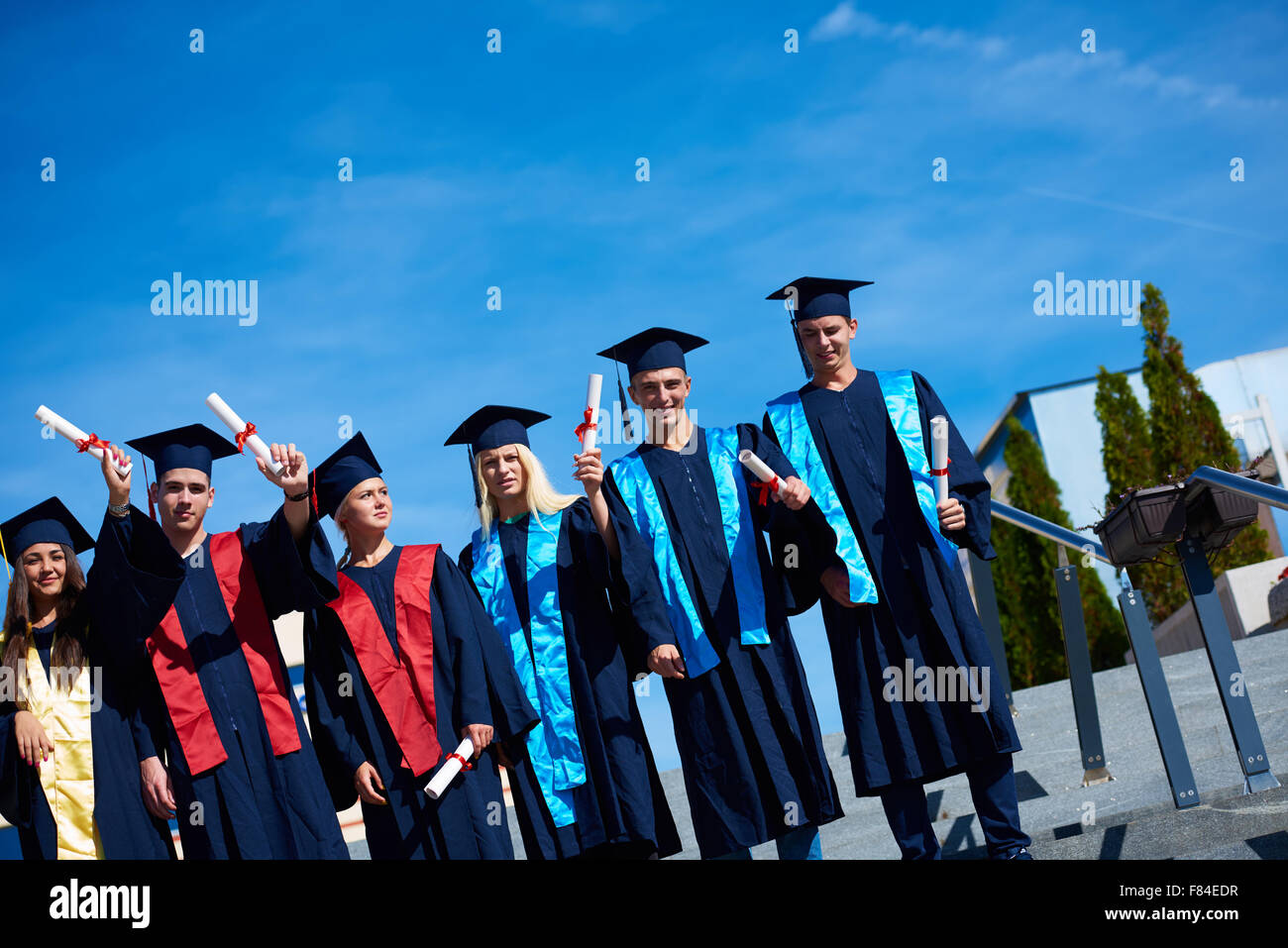 young graduates students group standing in front of university building ...