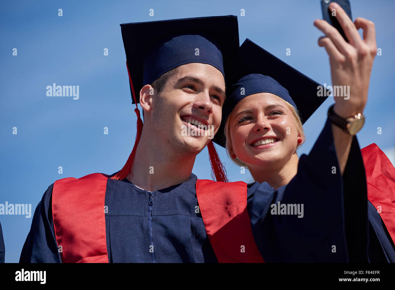 Capturing a happy moment.Students group college graduates in graduation ...