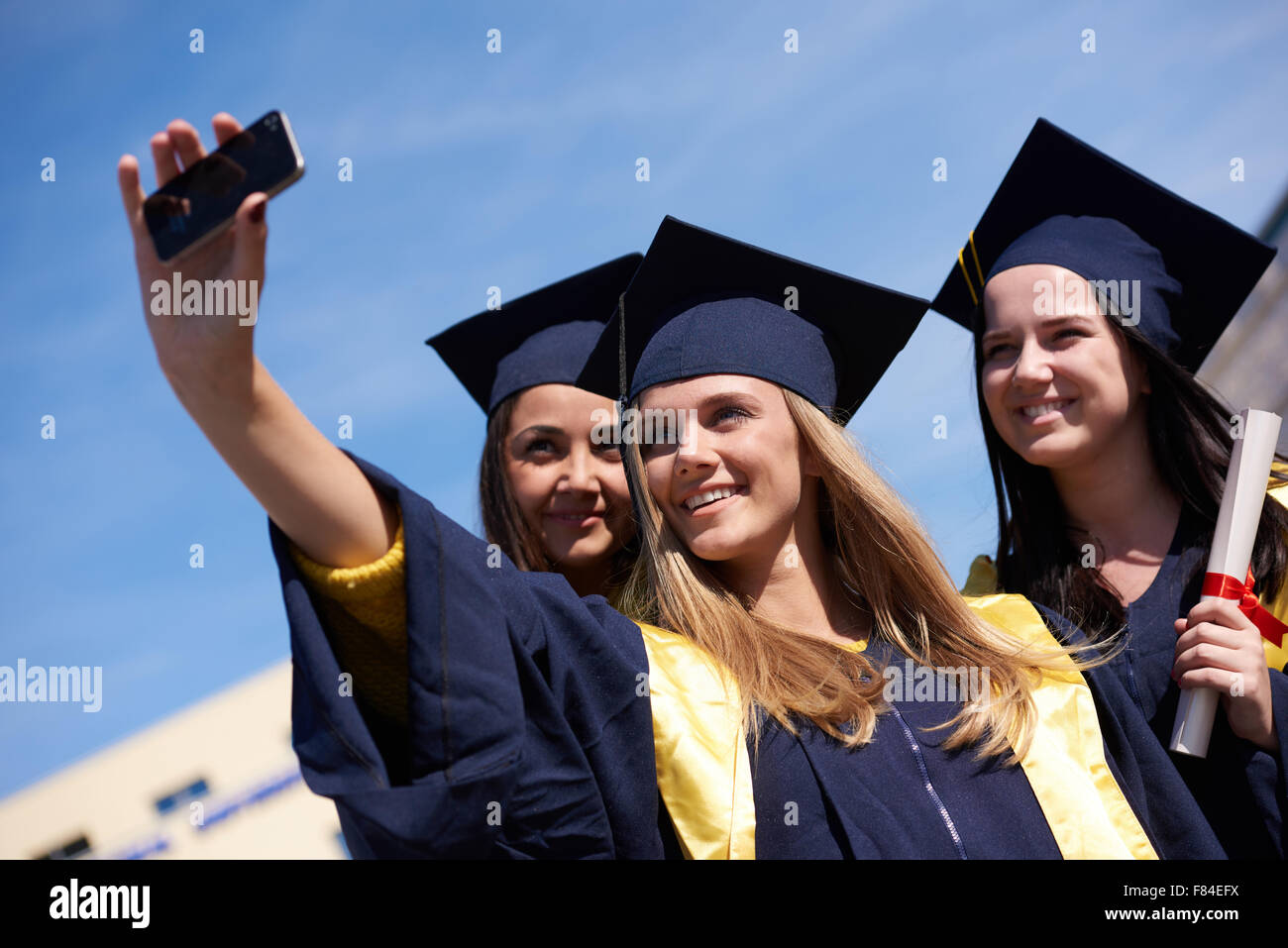 Capturing a happy moment.Students group college graduates in graduation ...