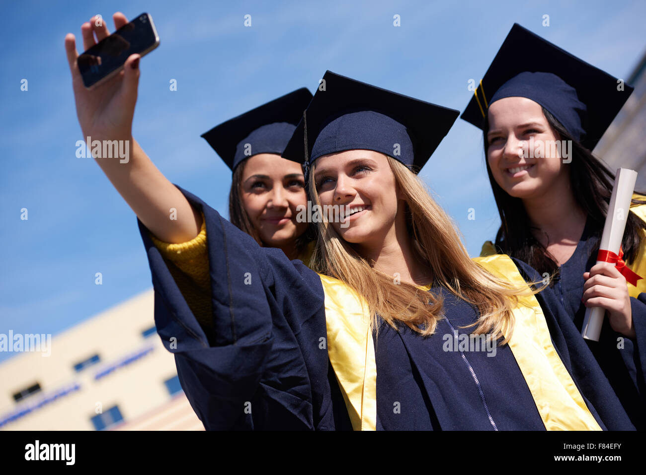Capturing a happy moment.Students group college graduates in graduation ...