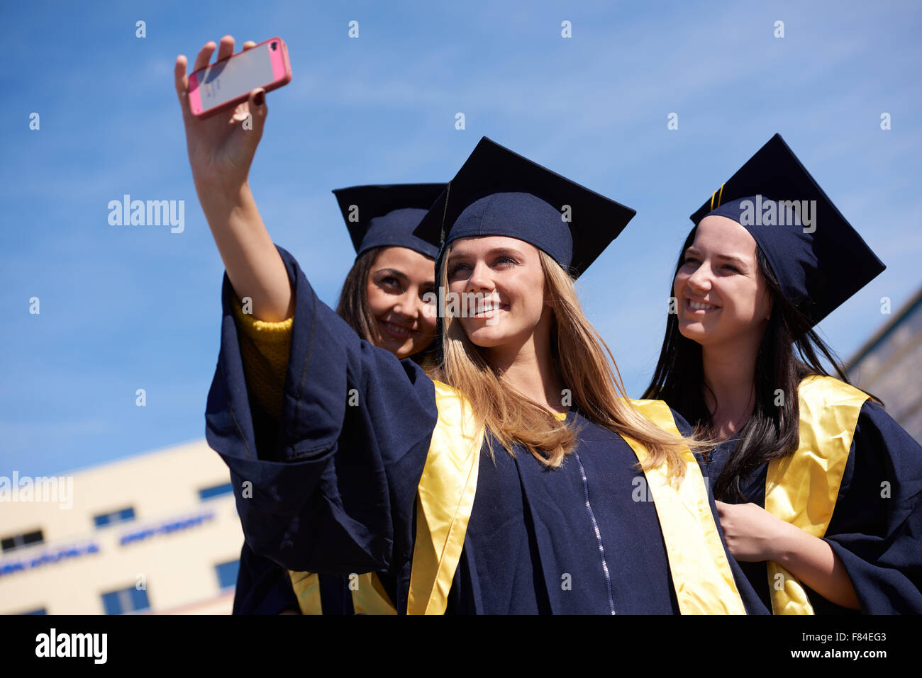 Capturing a happy moment.Students group college graduates in graduation ...