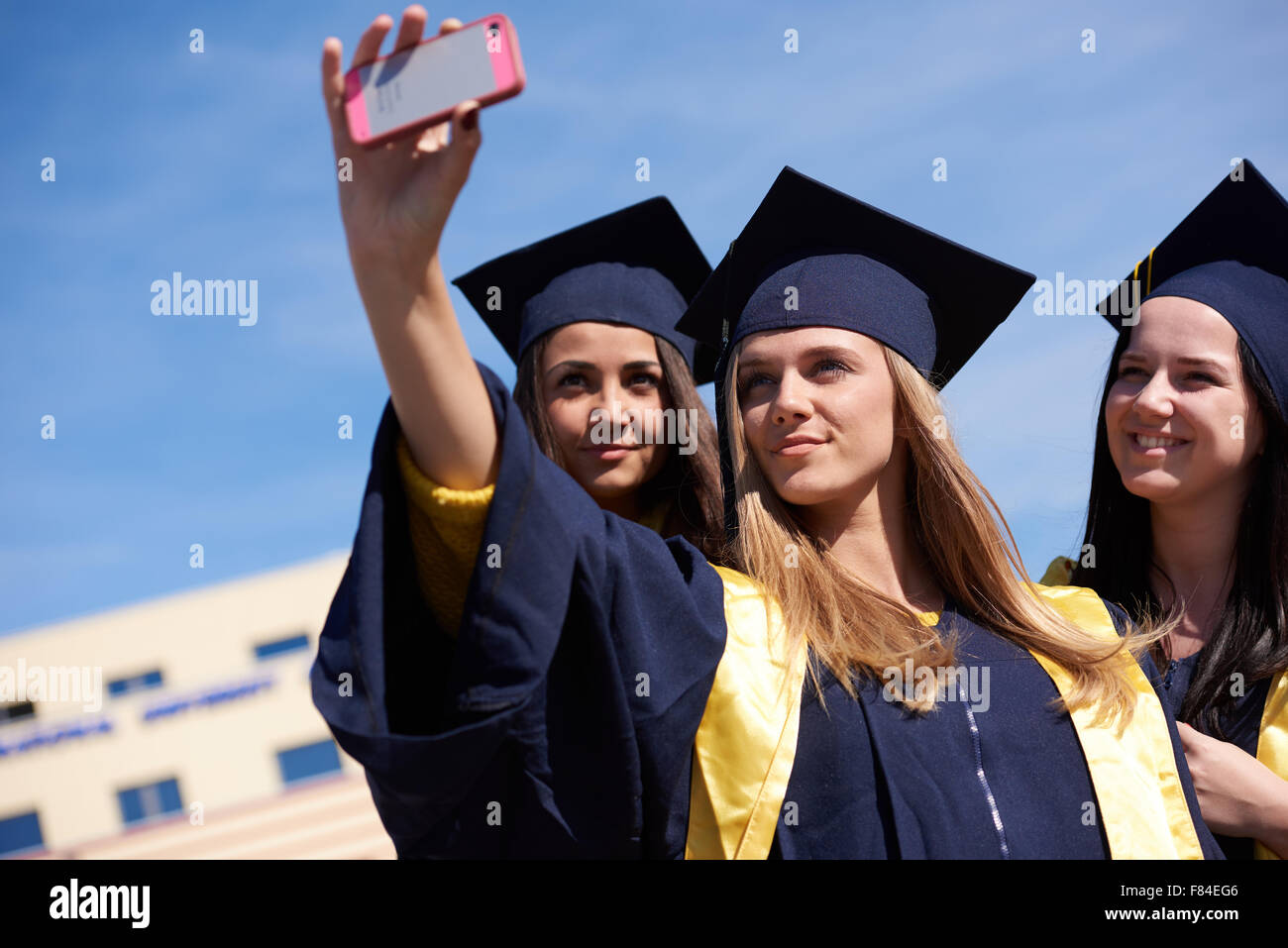 Capturing a happy moment.Students group college graduates in graduation ...