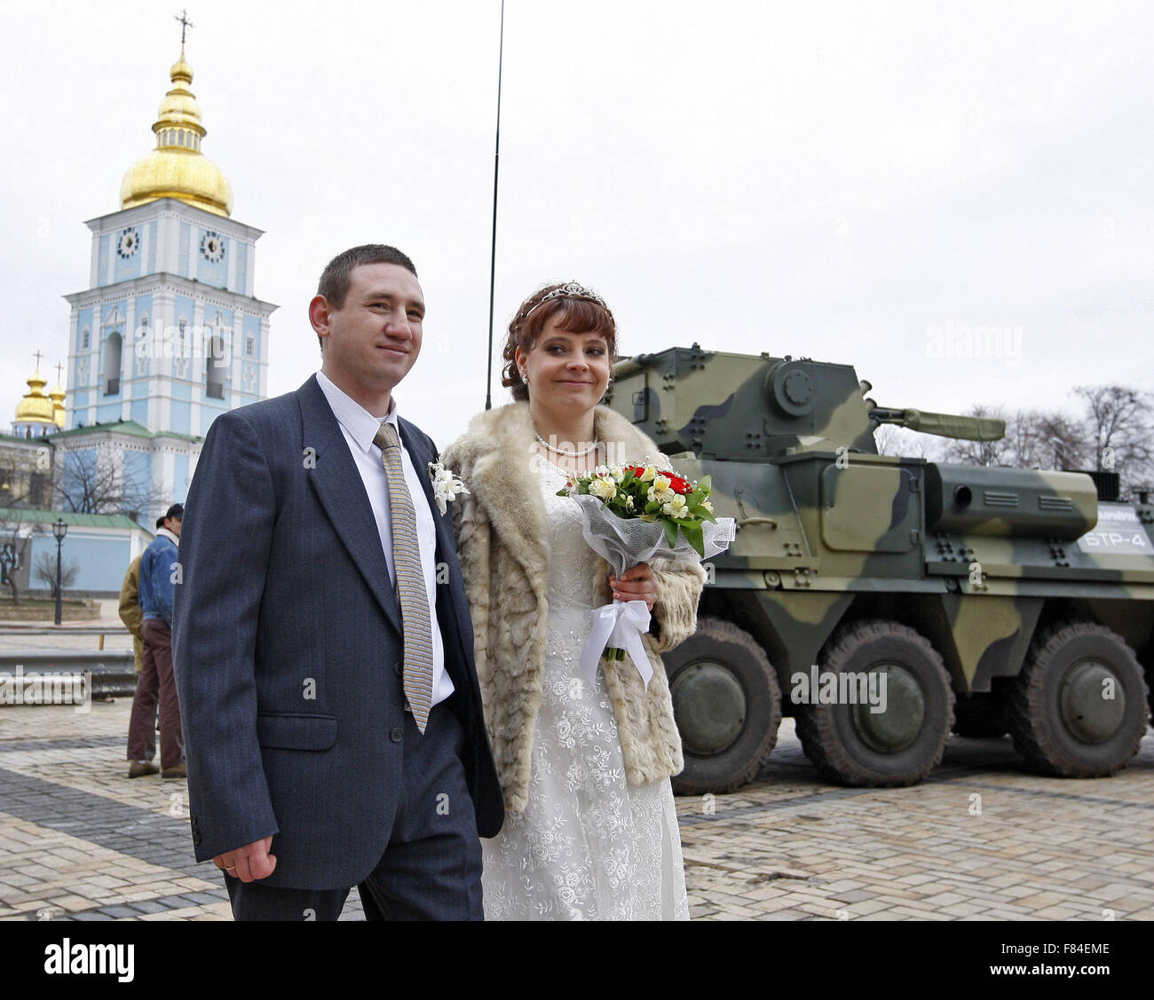 Kiev, Ukraine. 05th Dec, 2015. Ukrainian newlywed walks near the BTR-4 ...