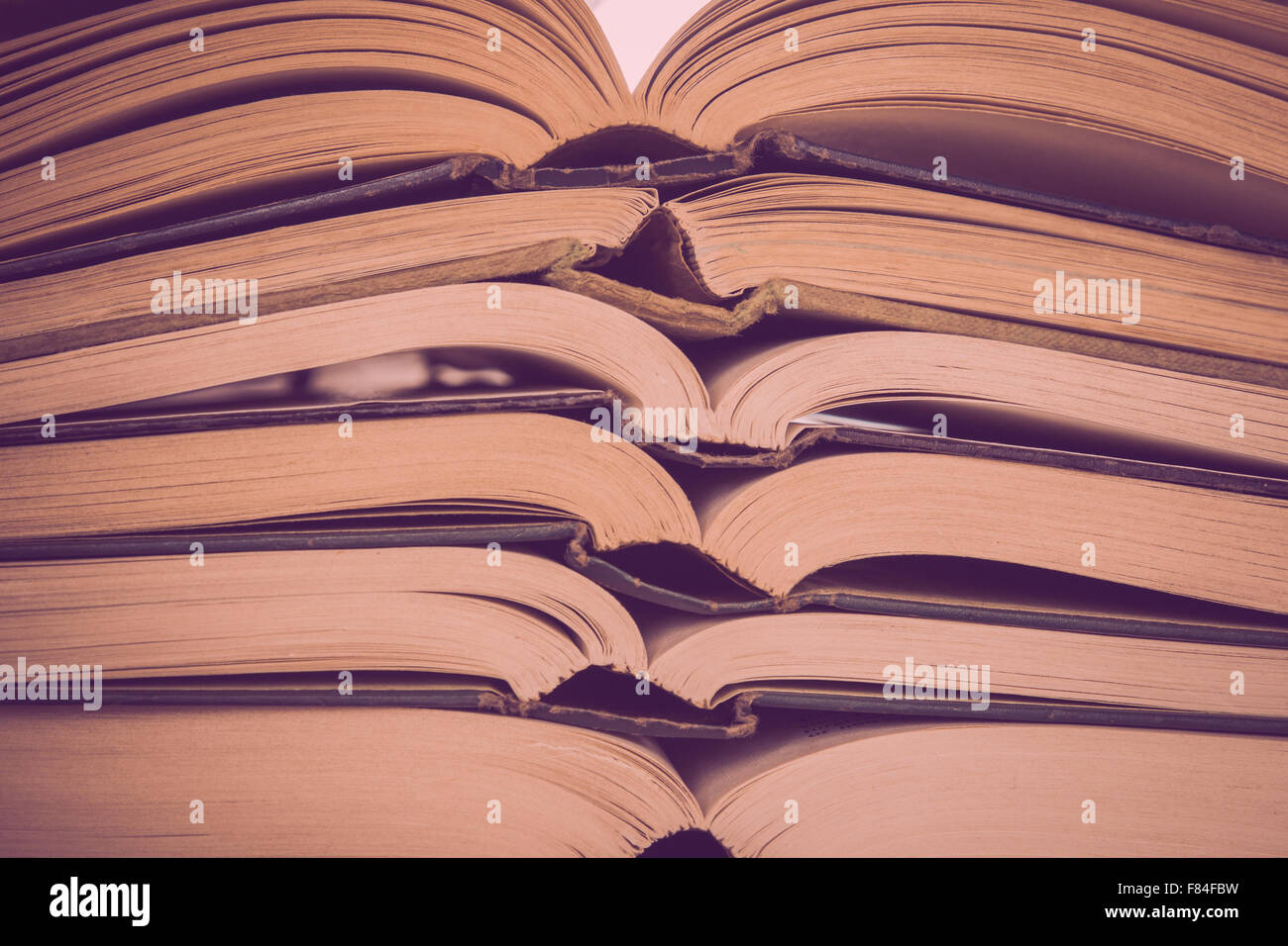 Stack of opened books with vintage filter effect Stock Photo - Alamy