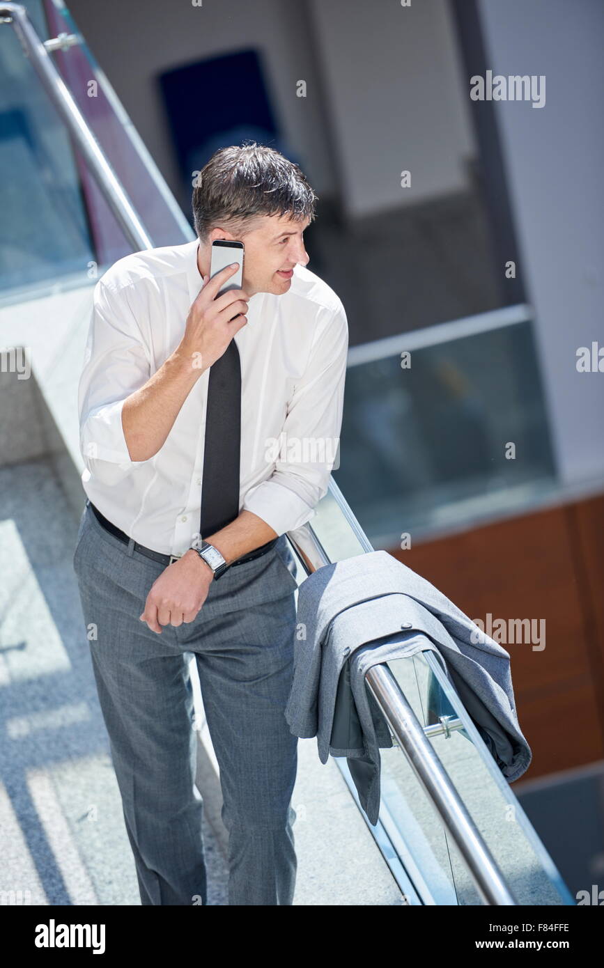 business man using phone at modern office space Stock Photo - Alamy