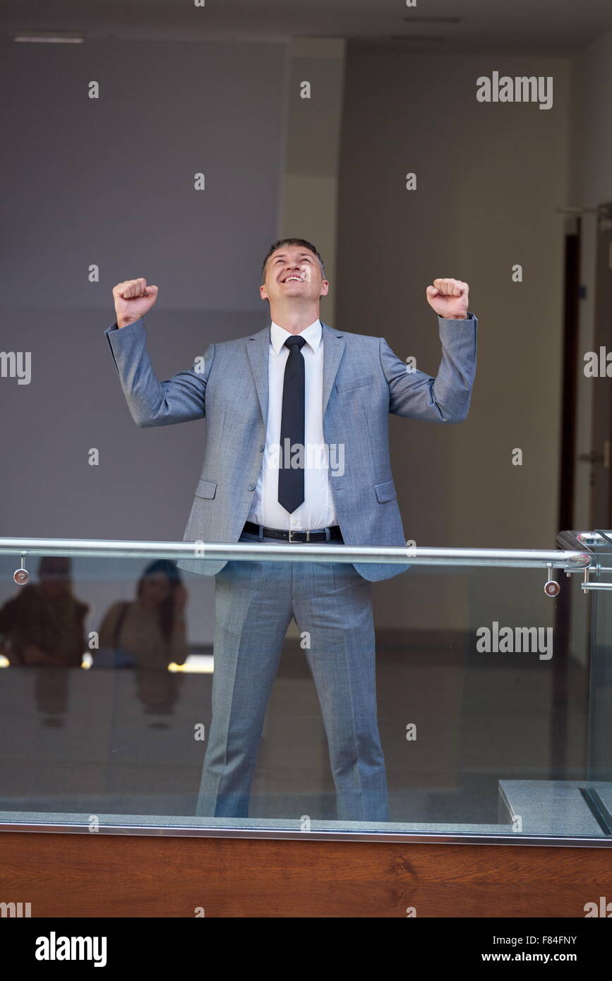 happy business man raise hands from joy at modern office Stock Photo ...