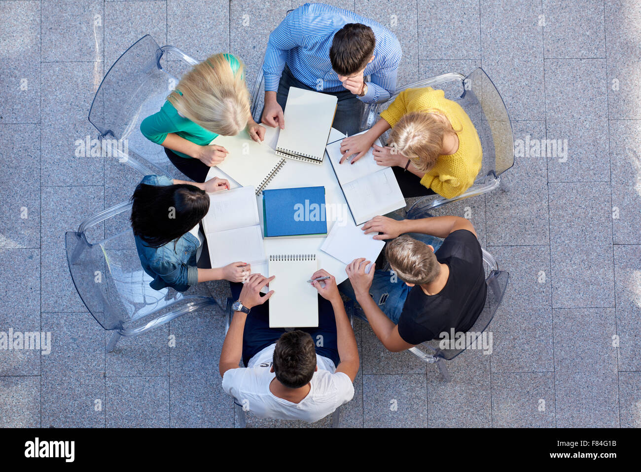 top view, group of students together at school table working homework ...