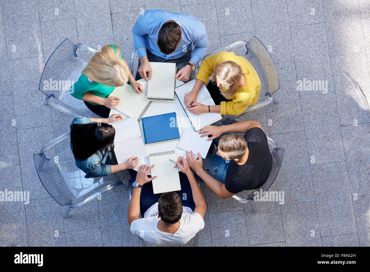 top view, group of students together at school table working homework ...